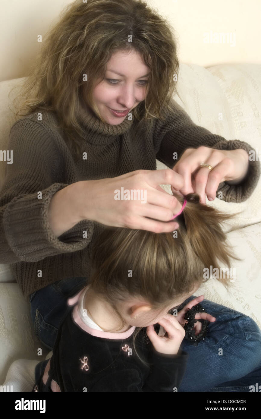 Adjusting fixing fix hair adjust hi-res stock photography and images ...