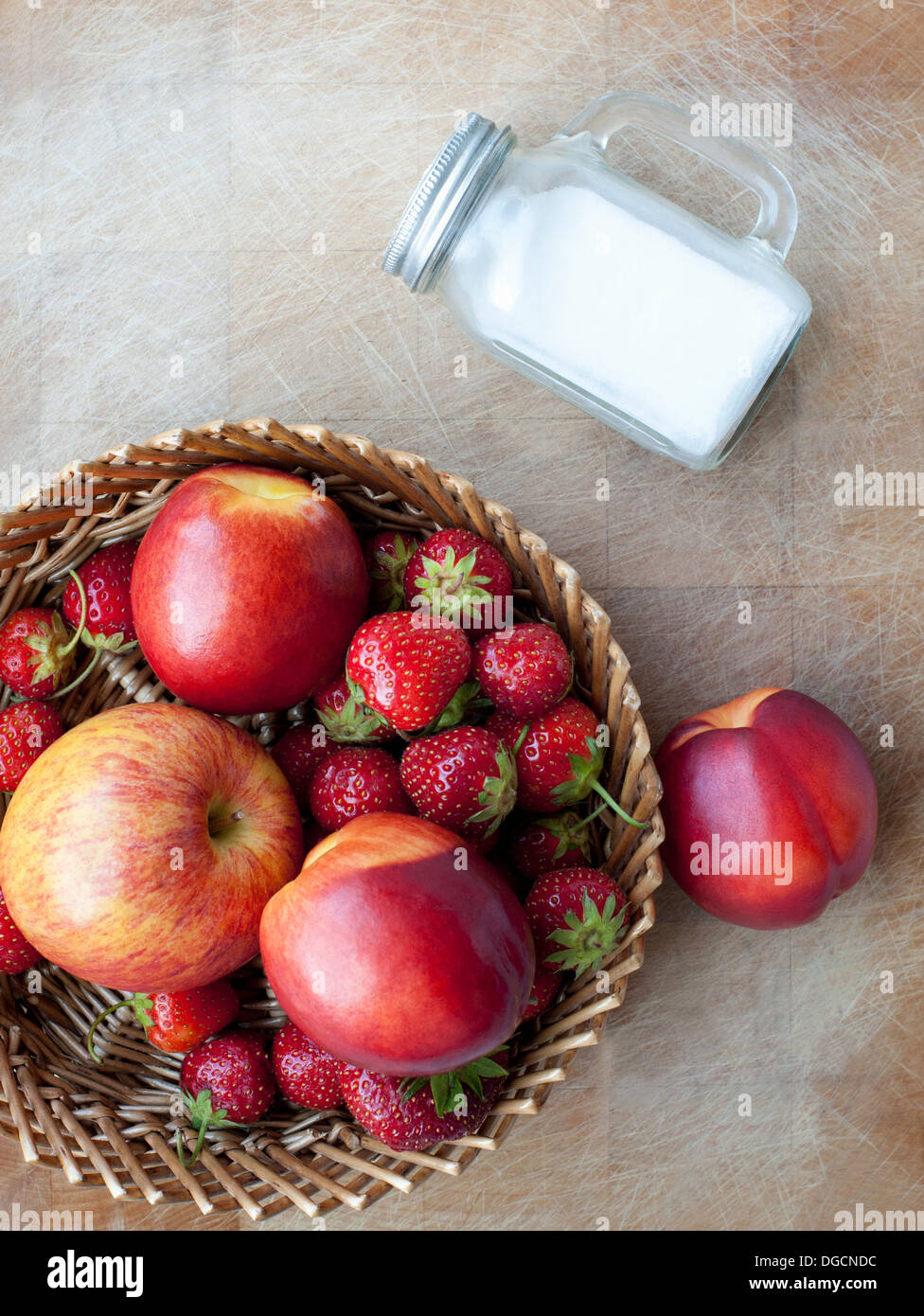 Basket of apple, peaches and strawberries, overhead view Stock Photo ...