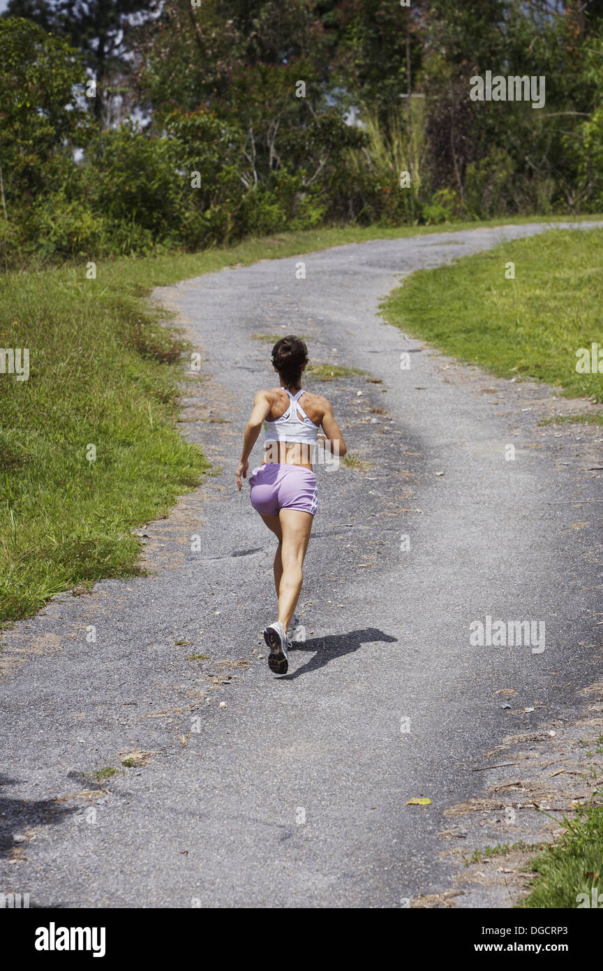Rear view of person running uphill hi-res stock photography and images ...