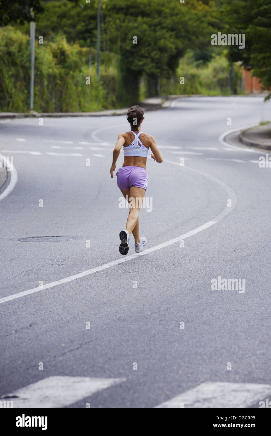 Rear view of person running uphill hi-res stock photography and images ...