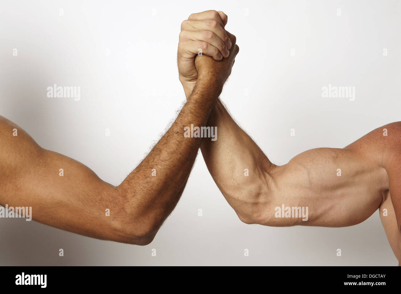 Two men: one super strong one normal arm wrestling Stock Photo - Alamy