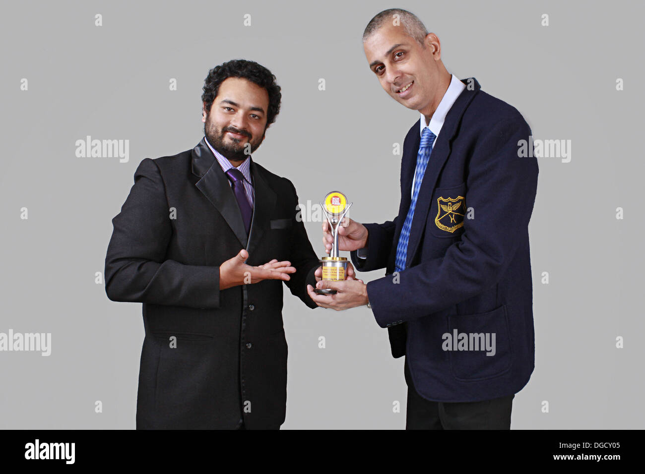 Two smiling businessmen with an award. Award ceremony Stock Photo - Alamy