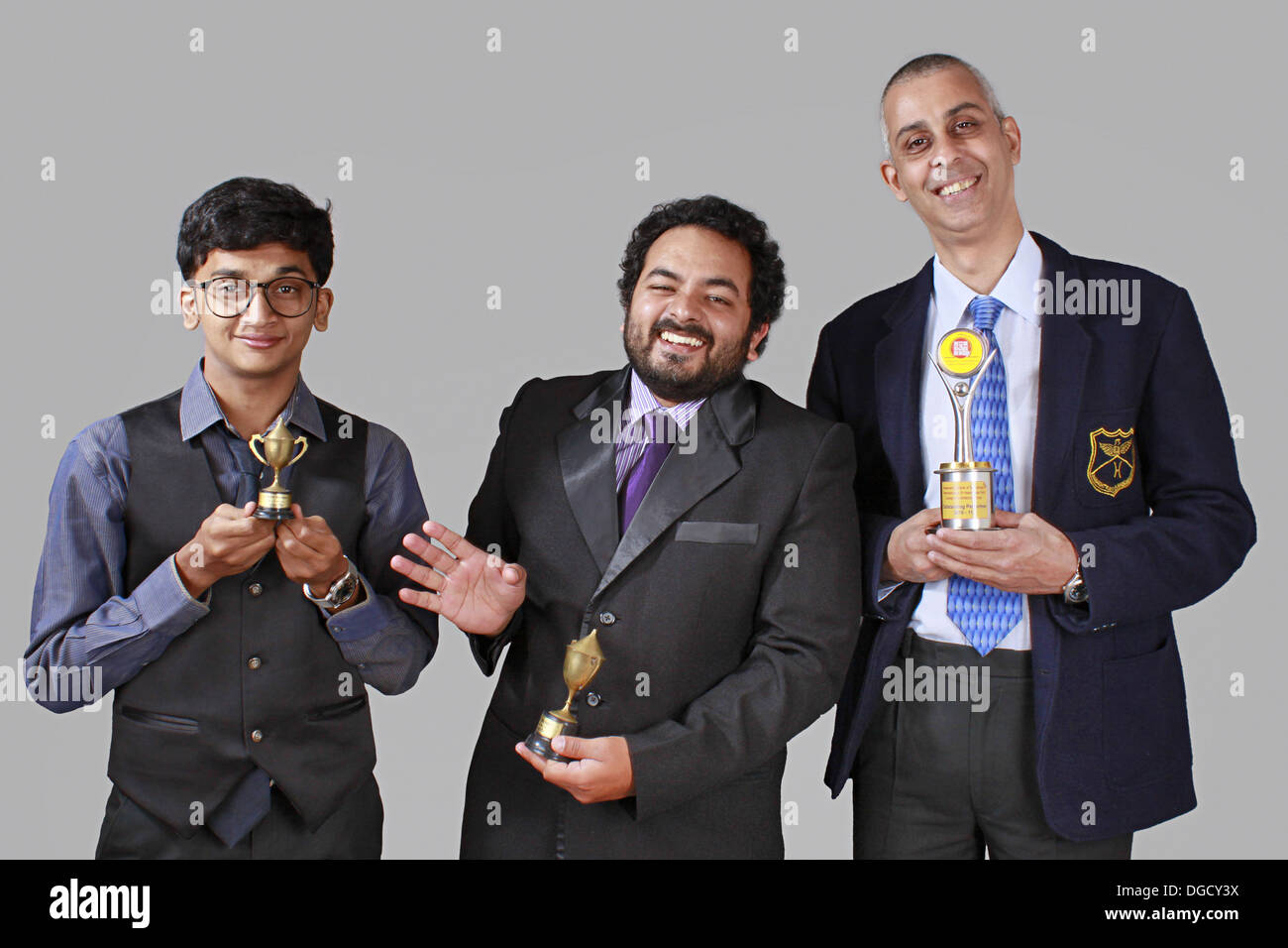 Three happy men in suits with awards. Award ceremony Stock Photo - Alamy