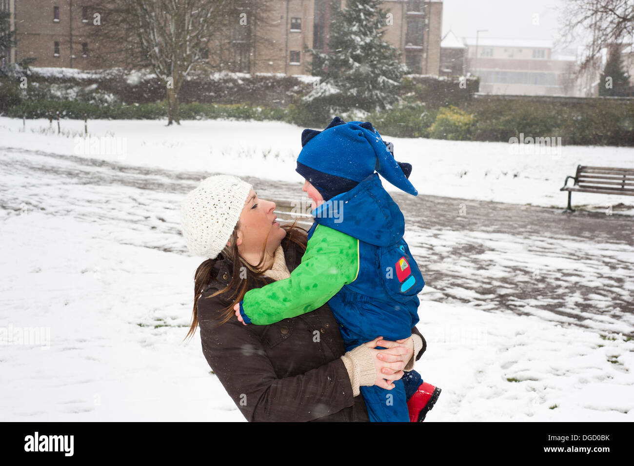 mum holding toddler in snow blizzard Stock Photo - Alamy