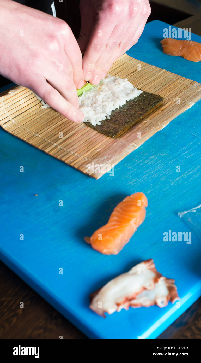 Sushi in sushi bar. Sushi making.Hands rolling sushi Stock Photo - Alamy