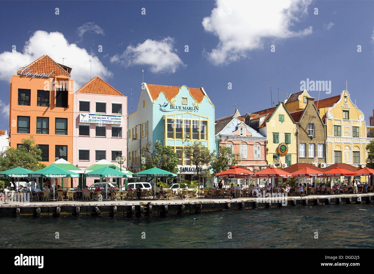 Brightly colored buildings with Dutch colonial architecture line the ...