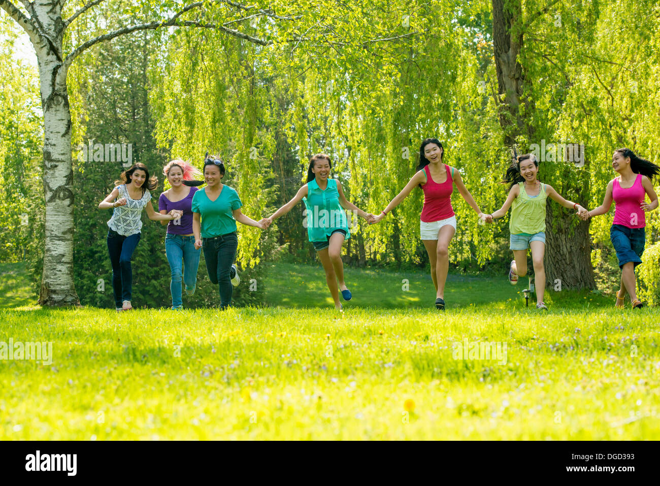 People running in park holding hands Stock Photo - Alamy