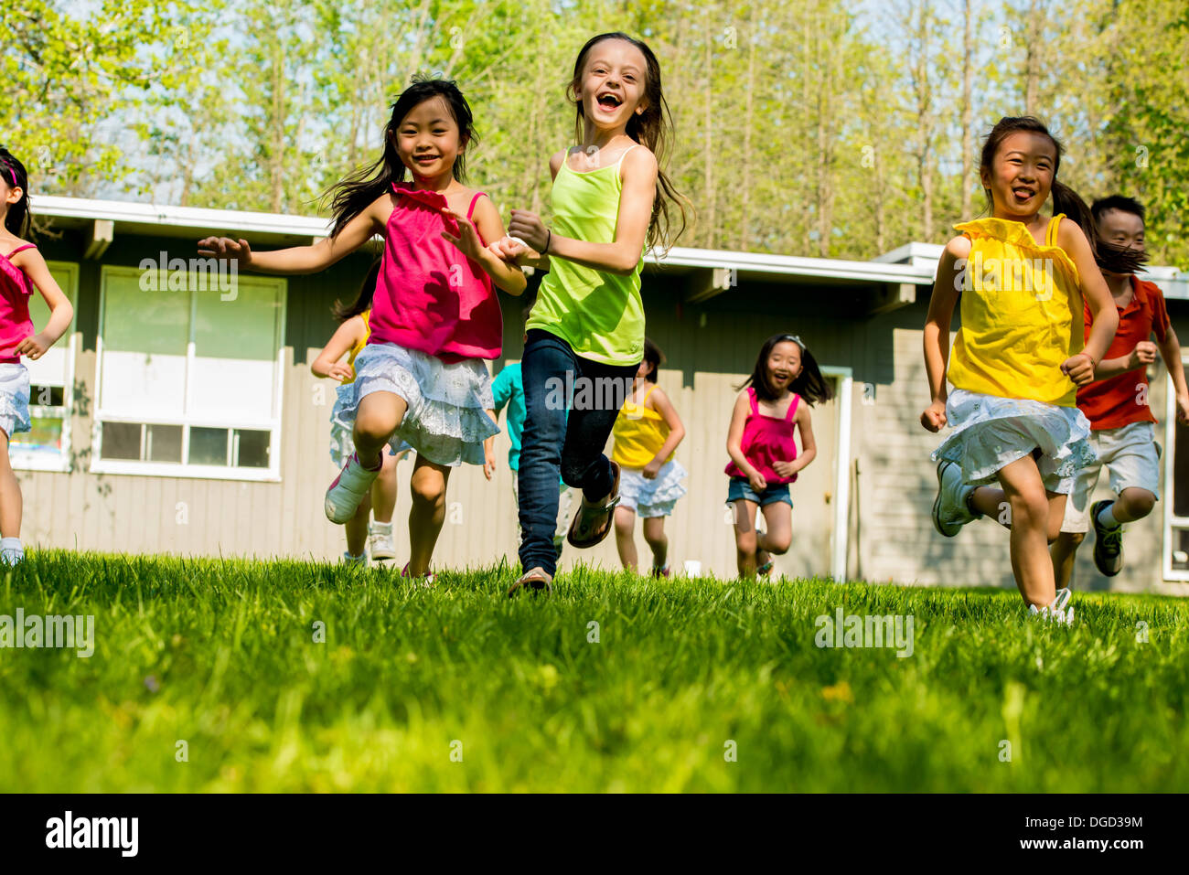 Children running on grass Stock Photo - Alamy
