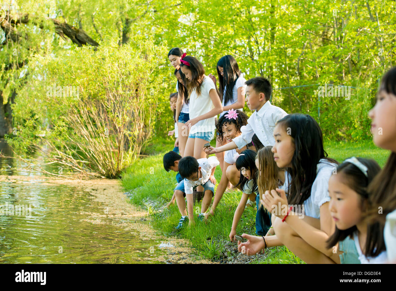 Children playing by lake Stock Photo - Alamy
