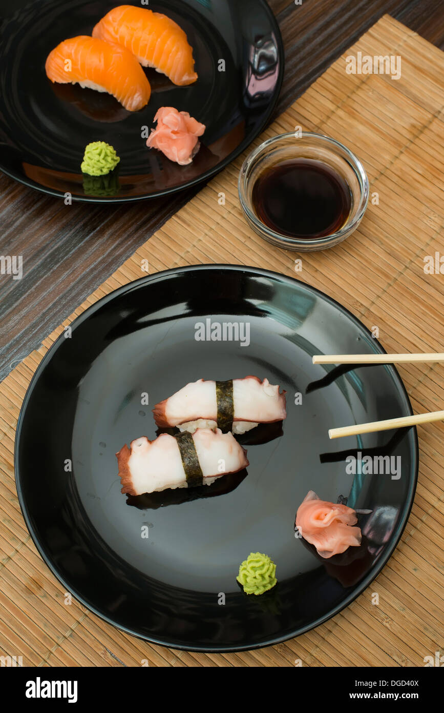 Sushi in sushi bar. Table and ration sushi Stock Photo - Alamy