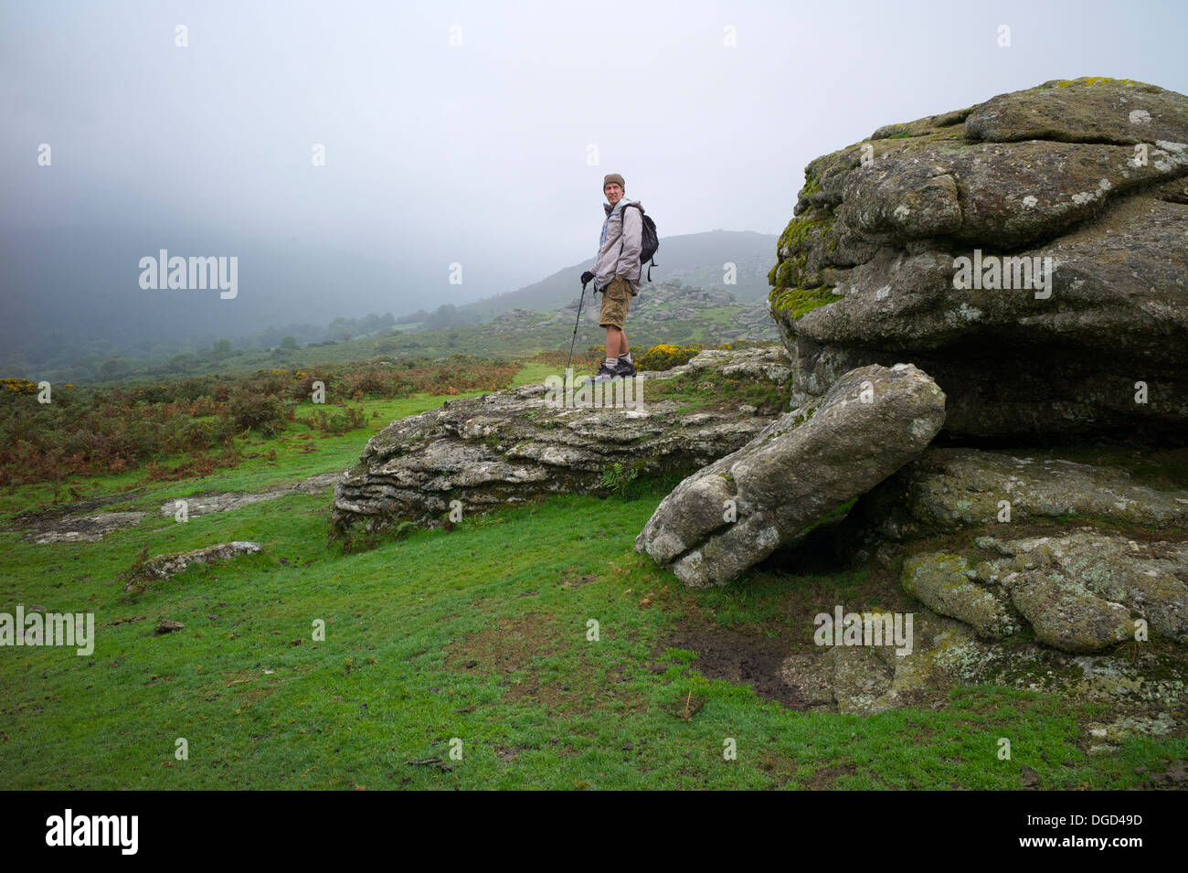 A hiker on Bonehill Rocks, Dartmoor, Devon UK Stock Photo - Alamy