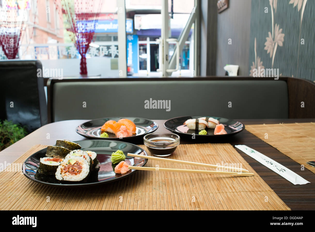 Sushi in sushi bar. Table and ration sushi Stock Photo - Alamy