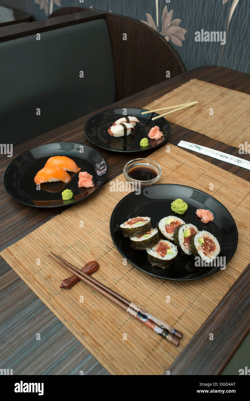 Sushi in sushi bar. Table and ration sushi Stock Photo - Alamy