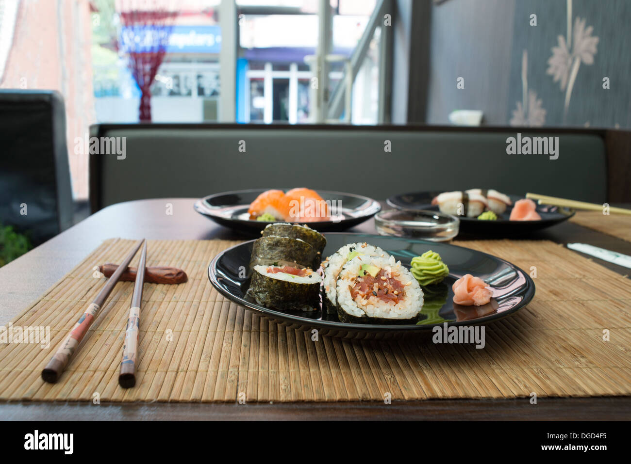 Sushi in sushi bar. Table and ration sushi Stock Photo - Alamy