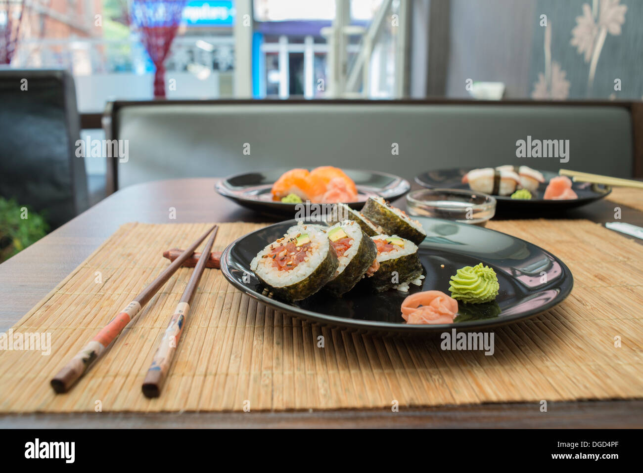 Sushi in sushi bar. Table and ration sushi Stock Photo - Alamy