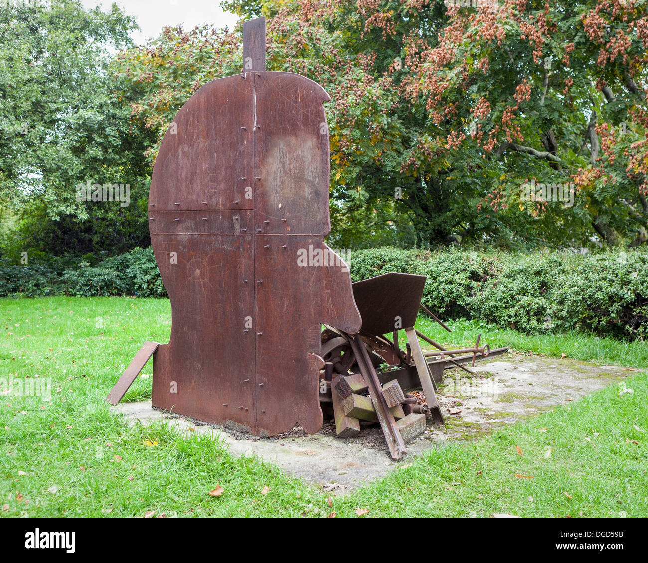 Public sculpture - Rusty head silhouette in front of railway tracks and ...
