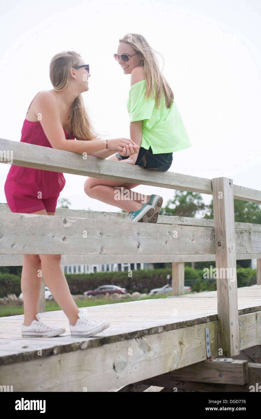 Two women standing sitting hi-res stock photography and images - Alamy