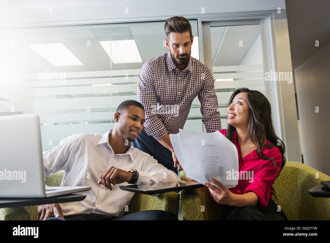Colleagues collaborating laptop documents hi-res stock photography and ...