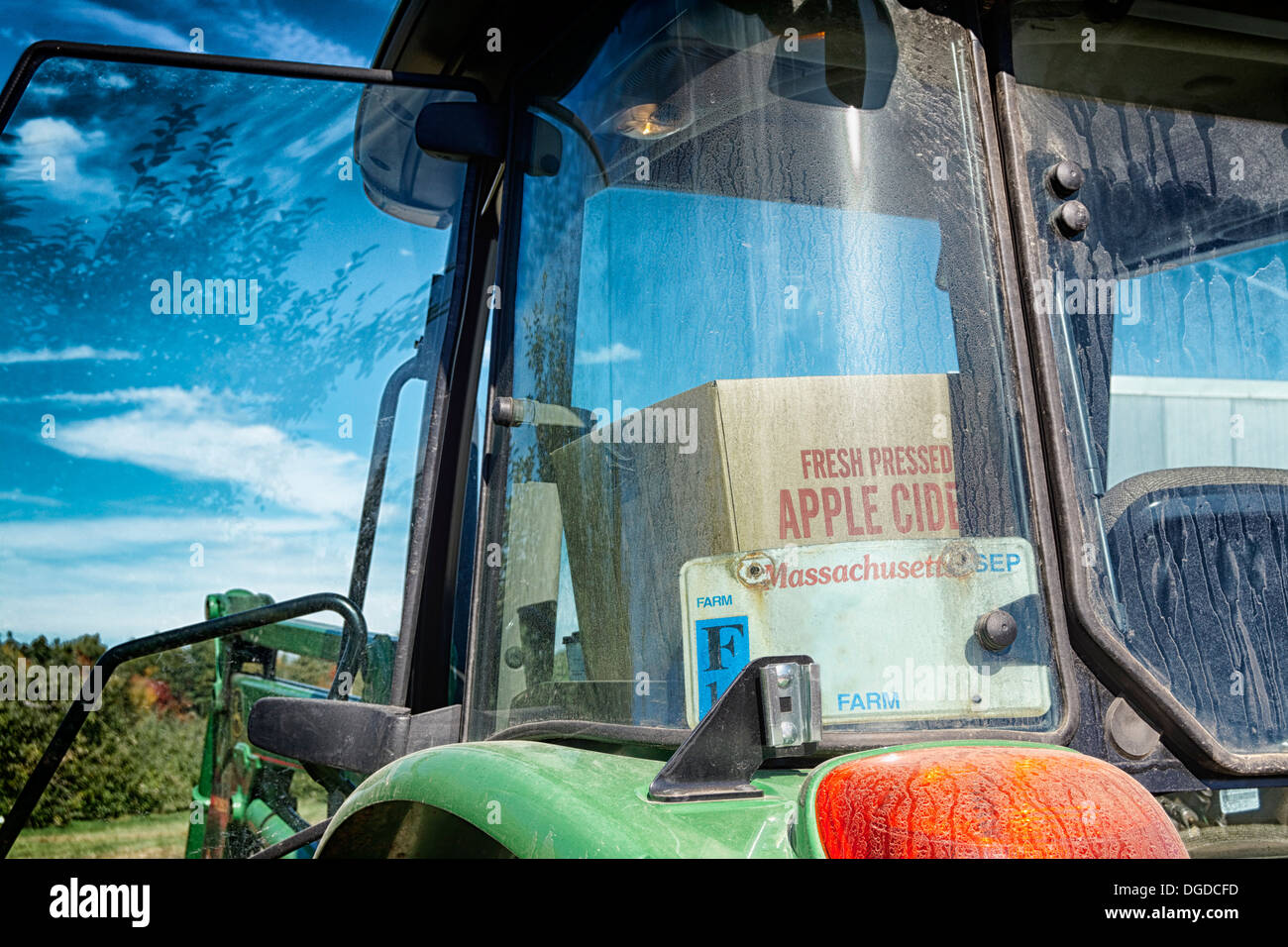 Rear of farm tractor with box of "Fresh Pressed Apple Cider" on seat ...