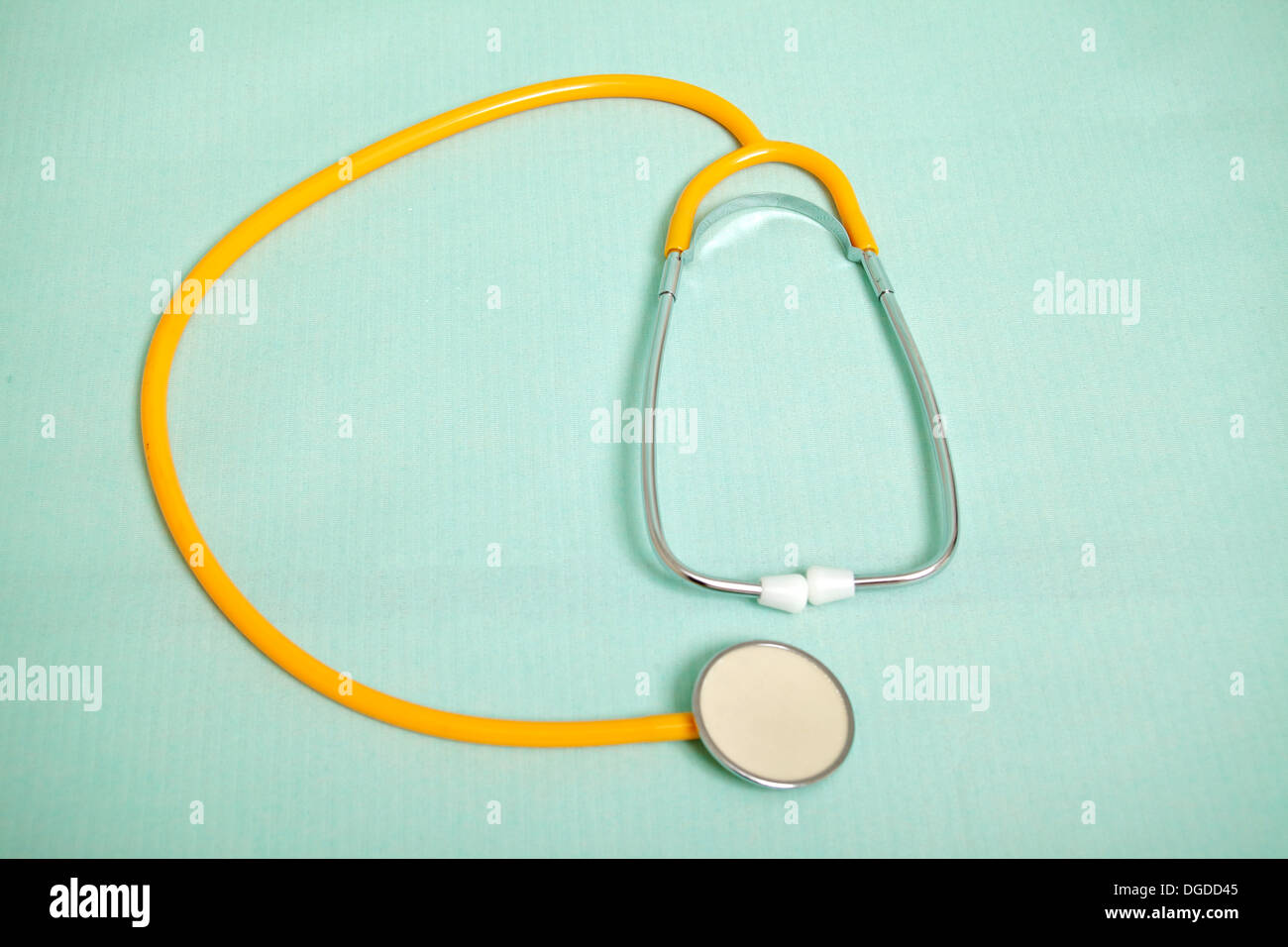 Yellow Stethoscope on green background Stock Photo - Alamy