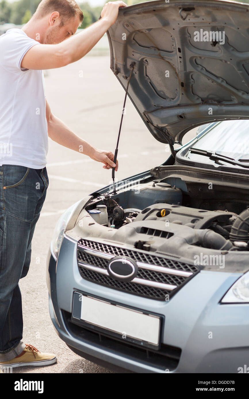 man opening car bonnet Stock Photo - Alamy