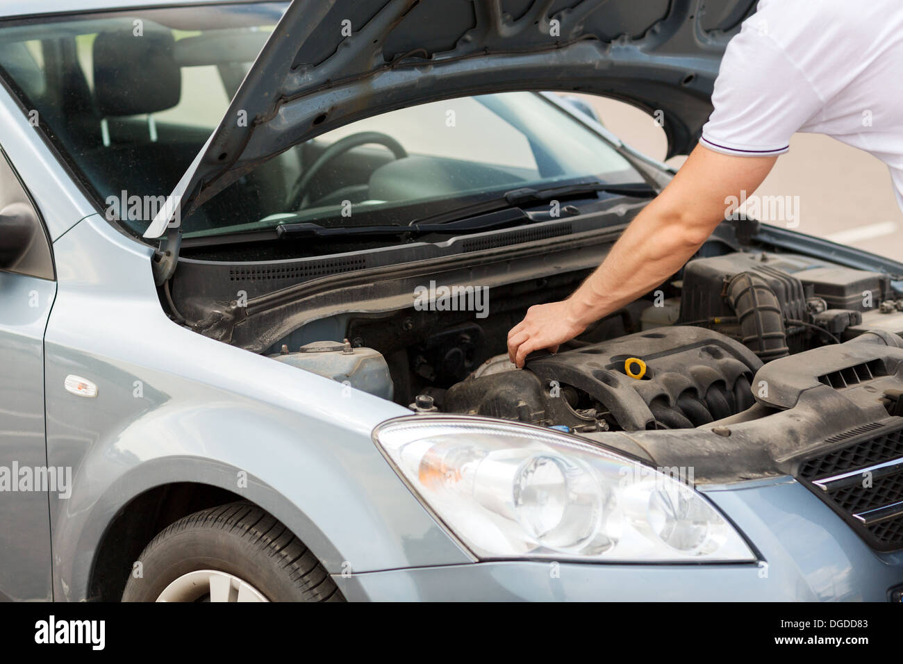 man opening car bonnet Stock Photo - Alamy