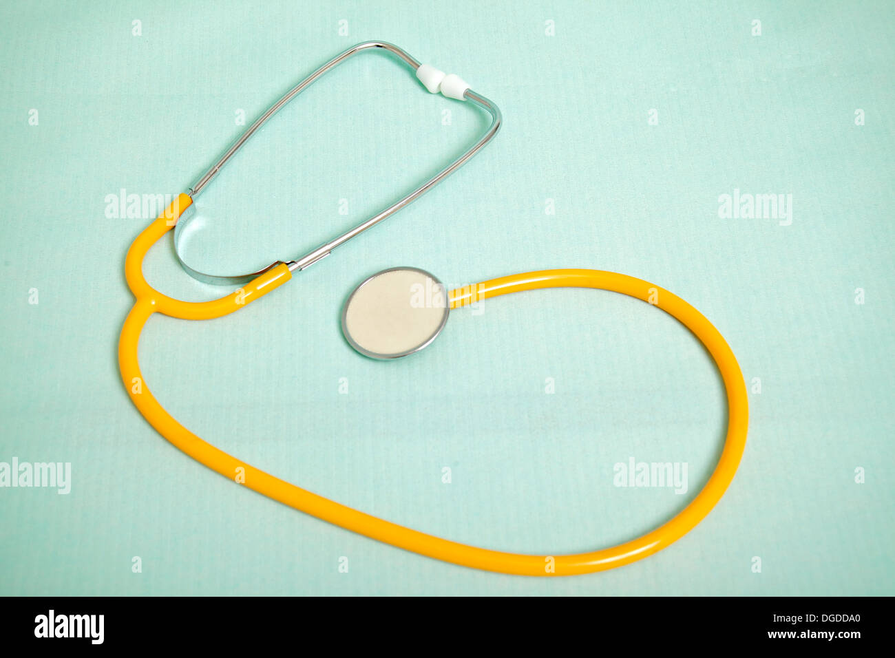 Yellow Stethoscope on green background Stock Photo - Alamy