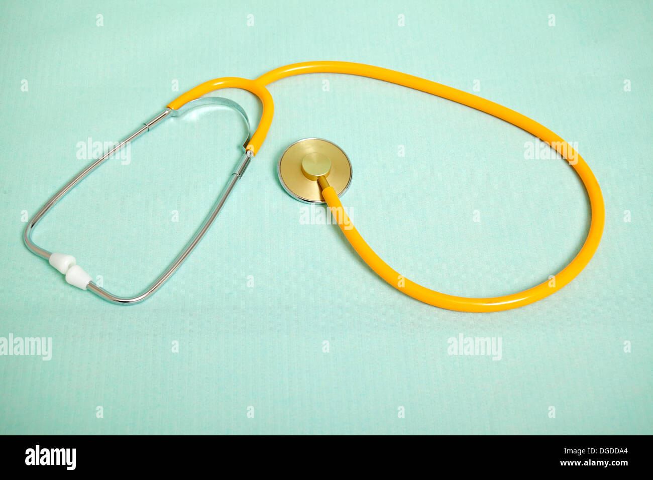Yellow Stethoscope on green background Stock Photo - Alamy