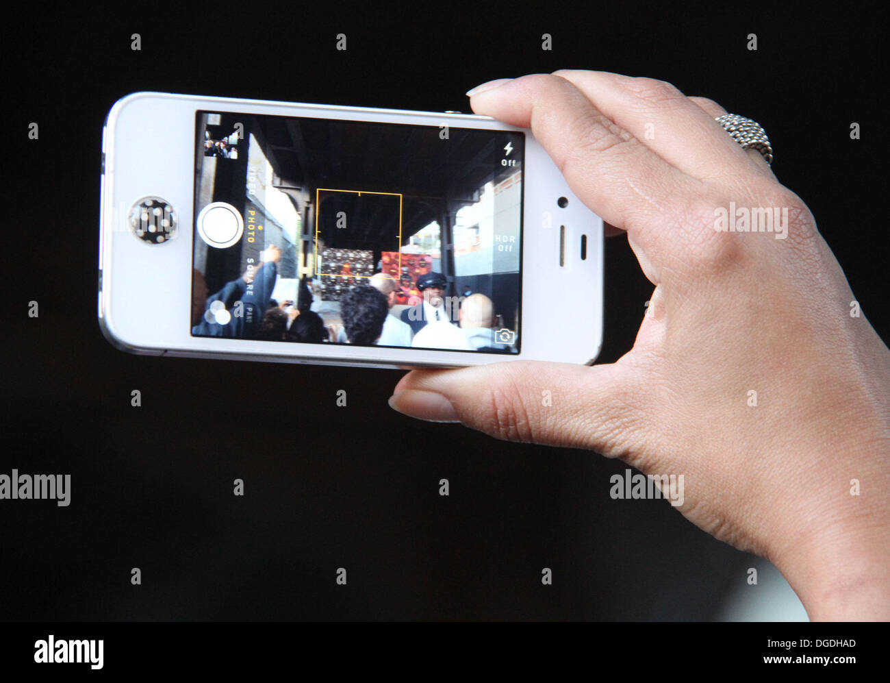 New York, USA. 18th Oct, 2013. A woman takes a cellphone photo of the ...