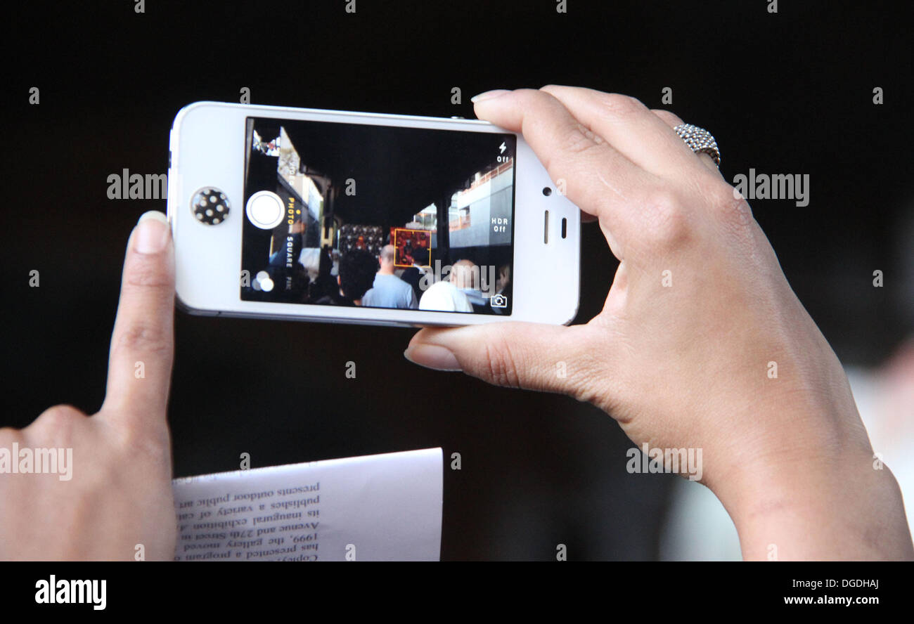 New York, USA. 18th Oct, 2013. A woman takes a cellphone photo of the ...