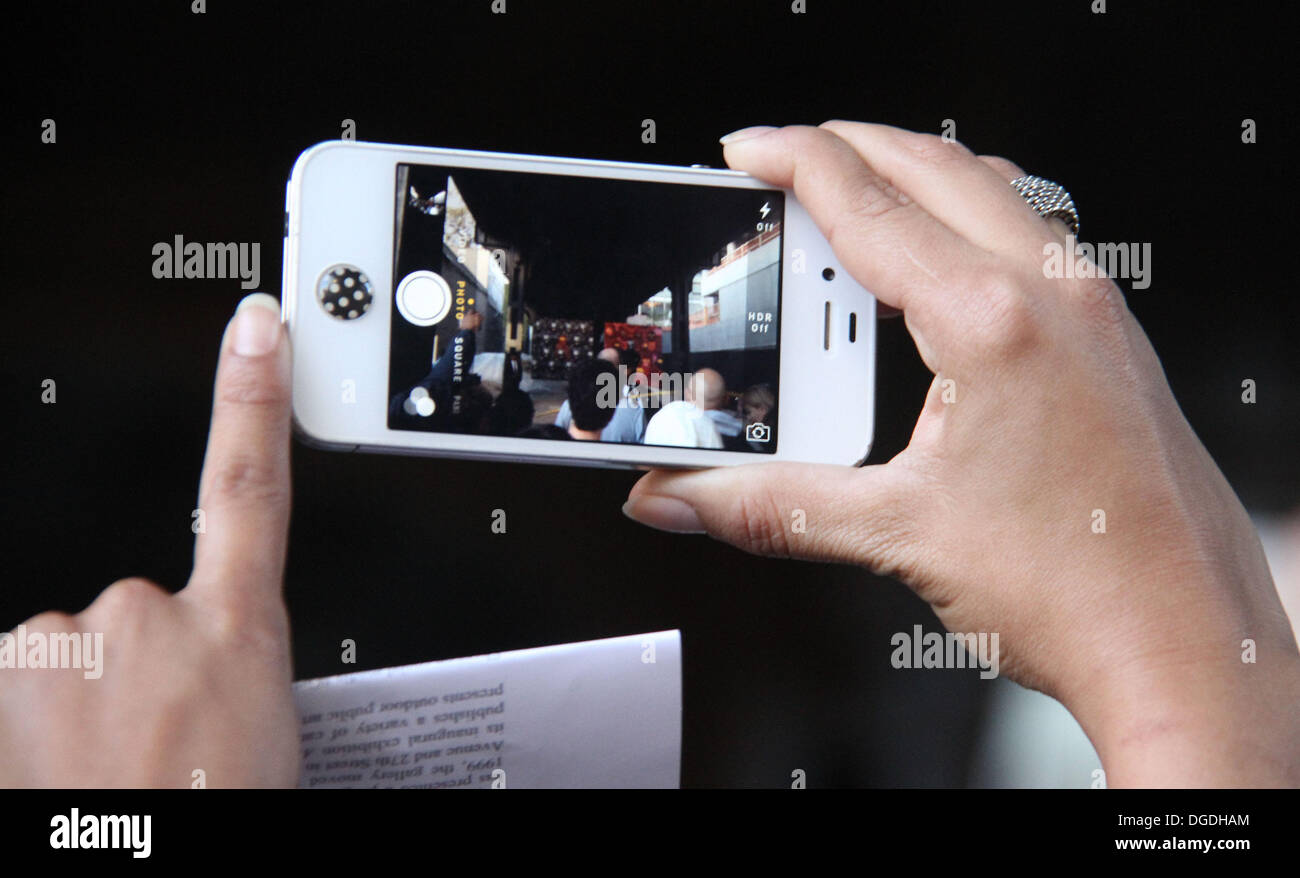 New York, USA. 18th Oct, 2013. A woman takes a cellphone photo of the ...