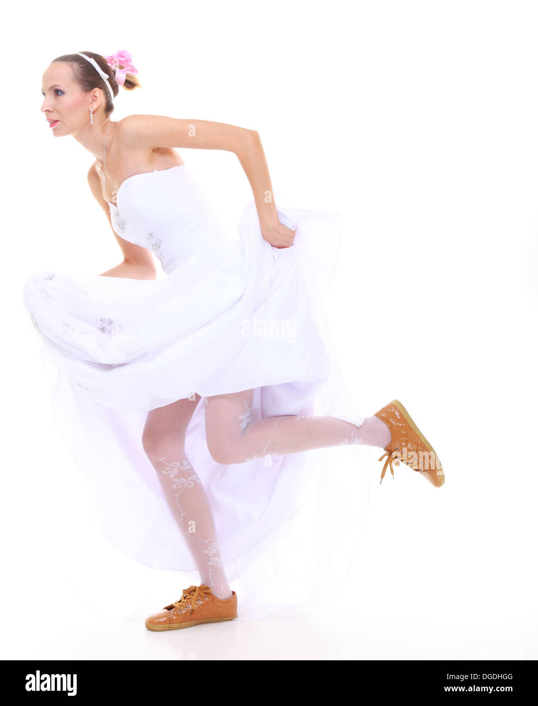 Wedding day. Running bride funny young woman wearing sporting shoes ...