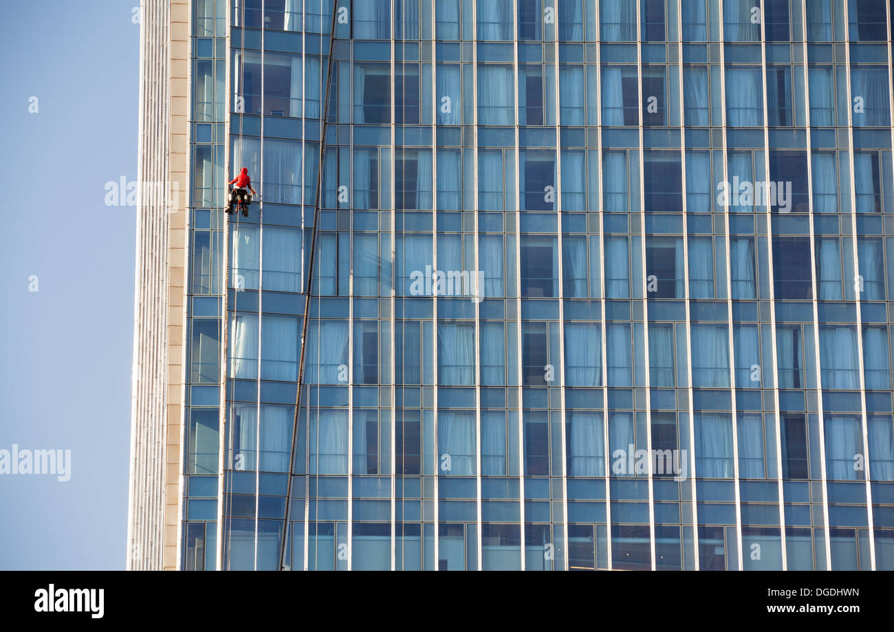 Worker cleaning windows of a tall building Stock Photo - Alamy