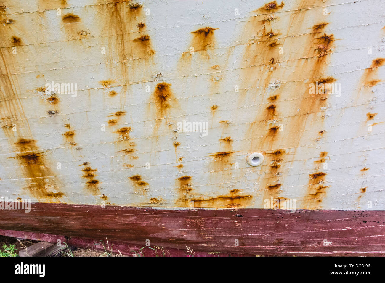 A close-up of an old fishing boat hull in a state of disrepair, with ...