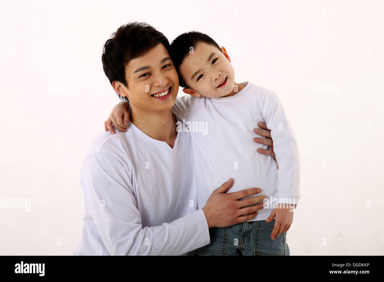East Asian Father Embracing Son, Smiling, Looking at the Camera Stock ...