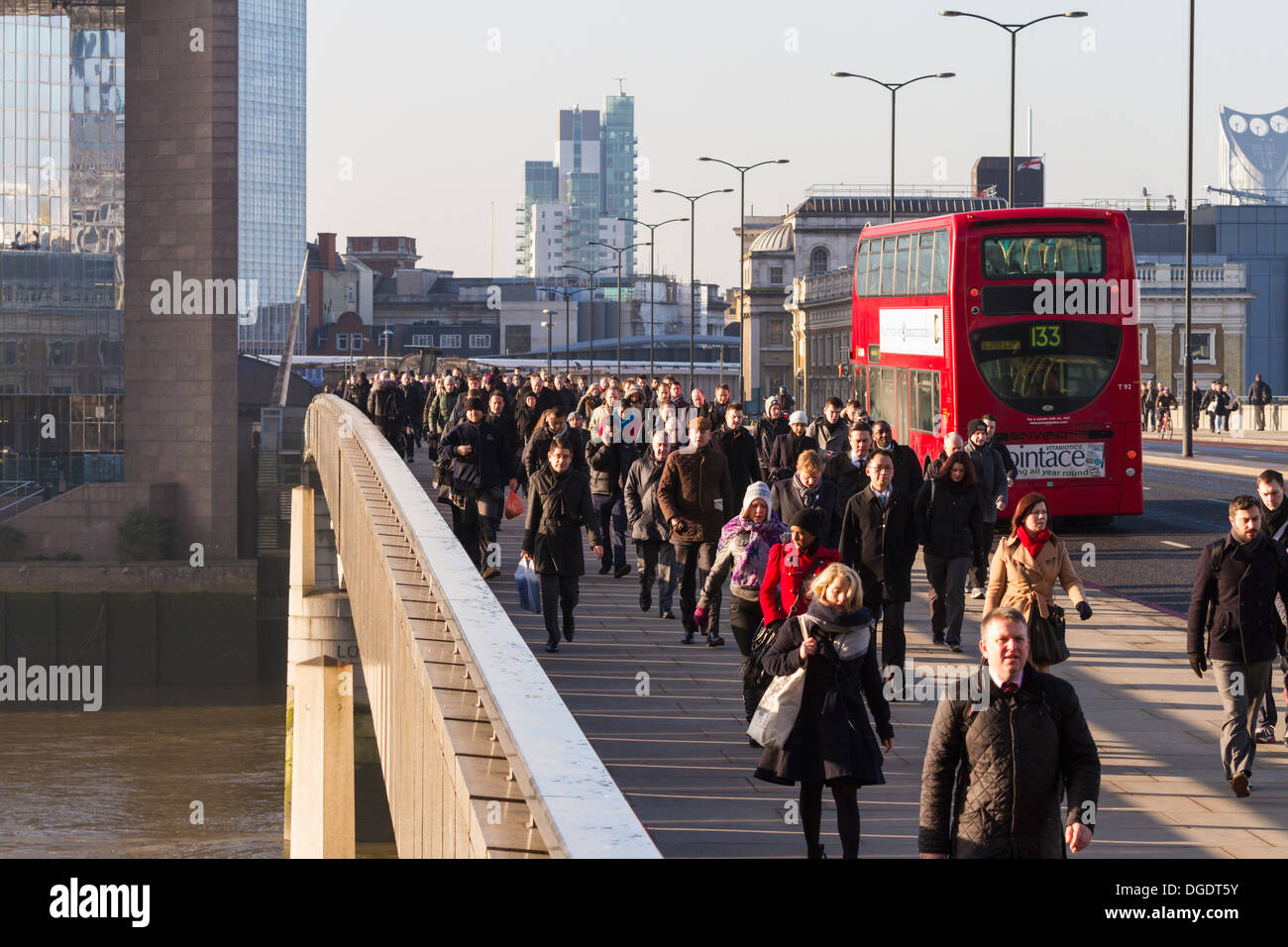 Early morning commuters cross London Bridge for the city on a cold ...