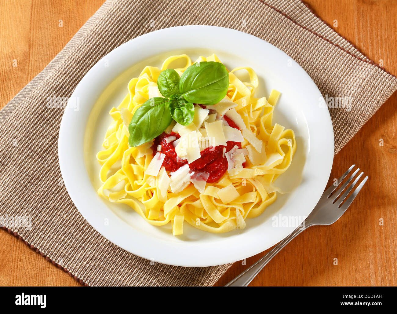 Tagliatelle pasta with tomato puree and Parmesan Stock Photo - Alamy