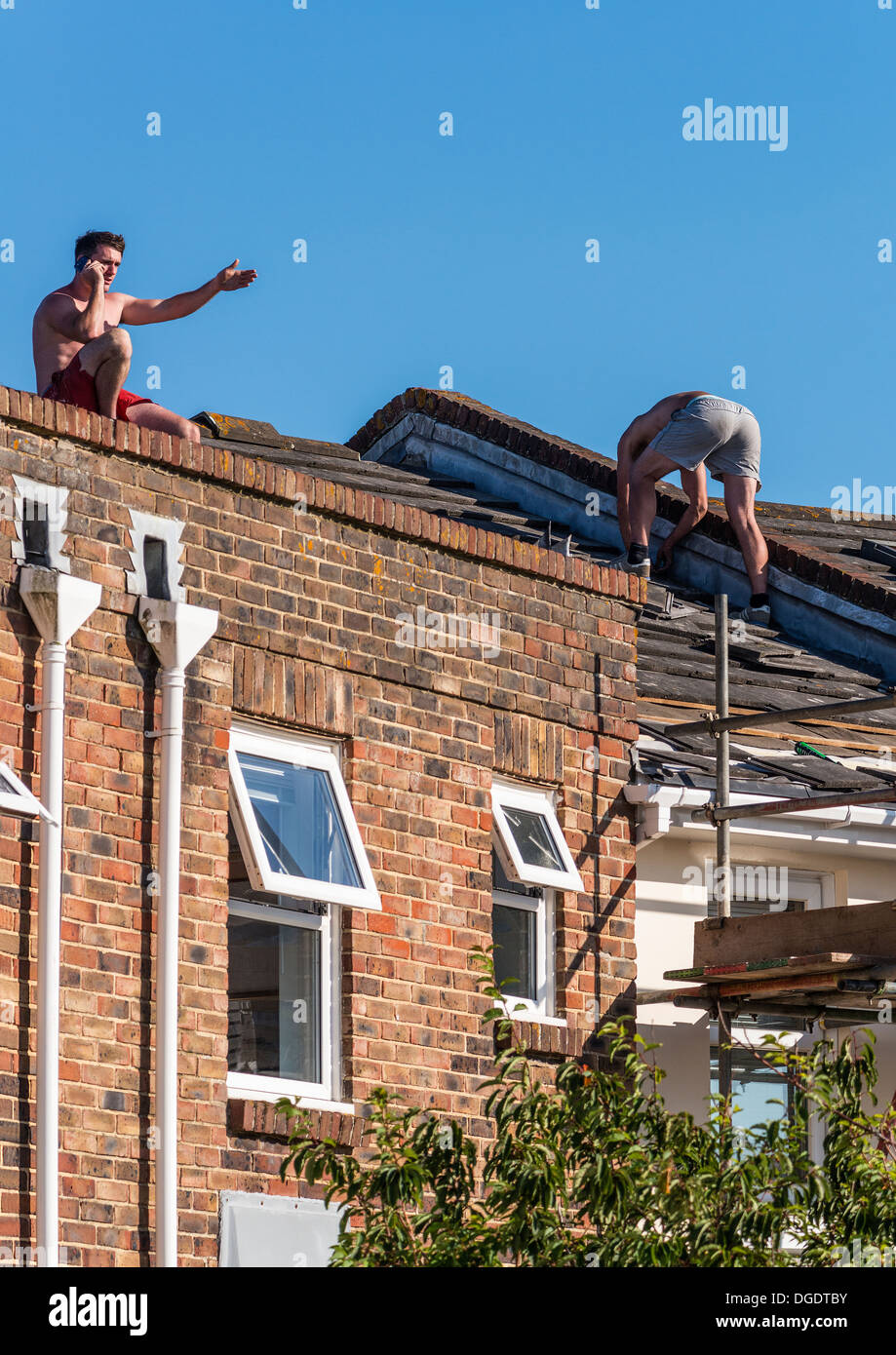 Sitting on roof tiles hi-res stock photography and images - Alamy