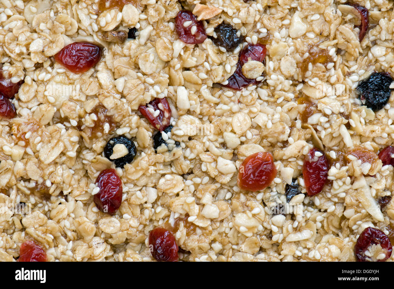 Cranberry and nut flapjack mixture flattened into backing tray Stock ...