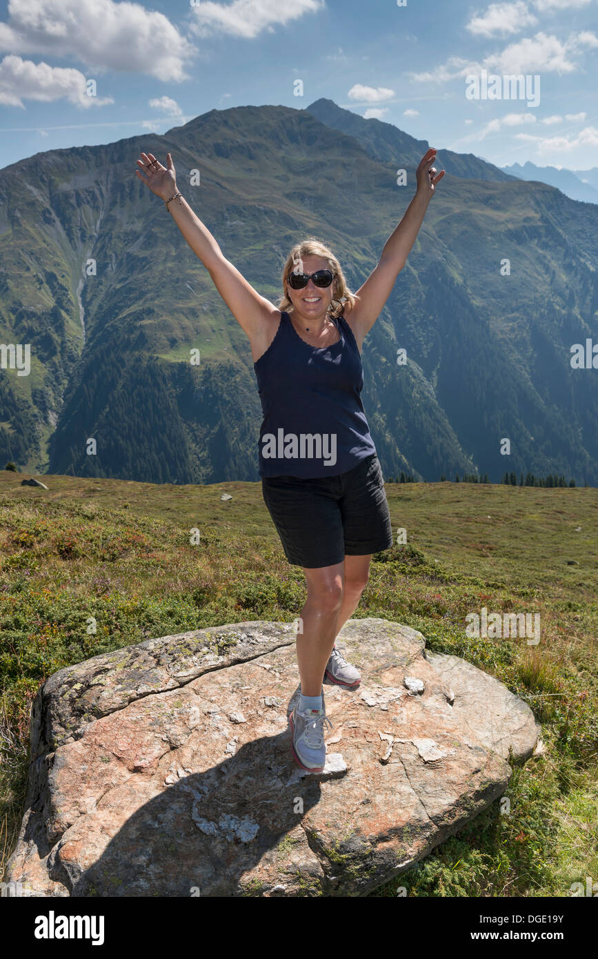 A female hiker waving from the Madrisa to Klosters hiking tour ...