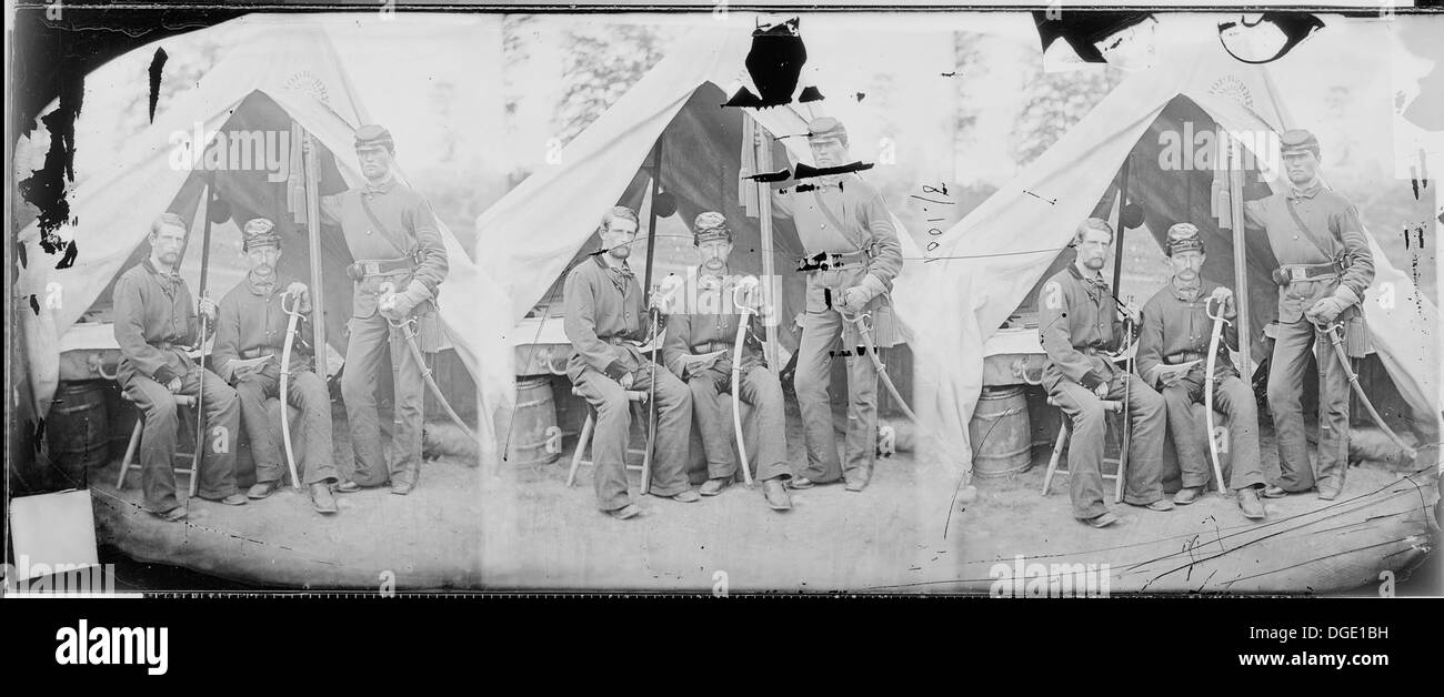 A group of artillery soldiers stand at attention, representing a unit ...