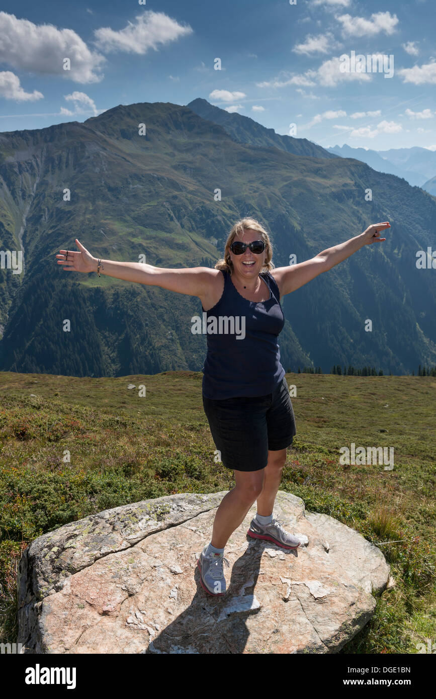 A female hiker waving from the Madrisa to Klosters hiking tour ...