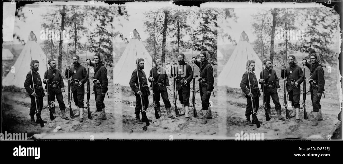 A group of infantry soldiers posed for a photograph, capturing military ...