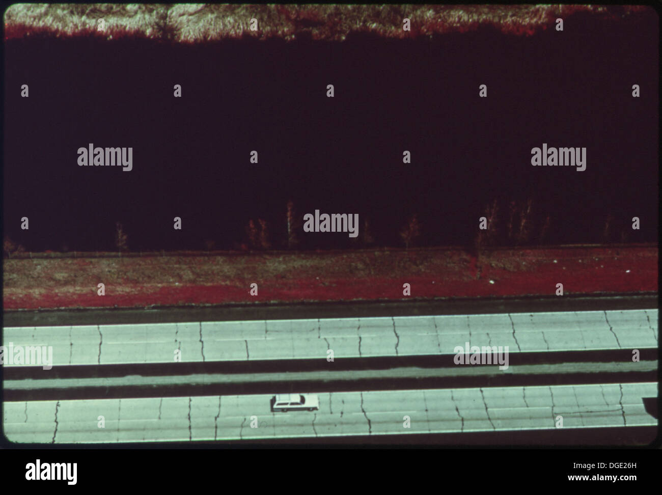This image captures a scene showing both a highway and a waterway side ...