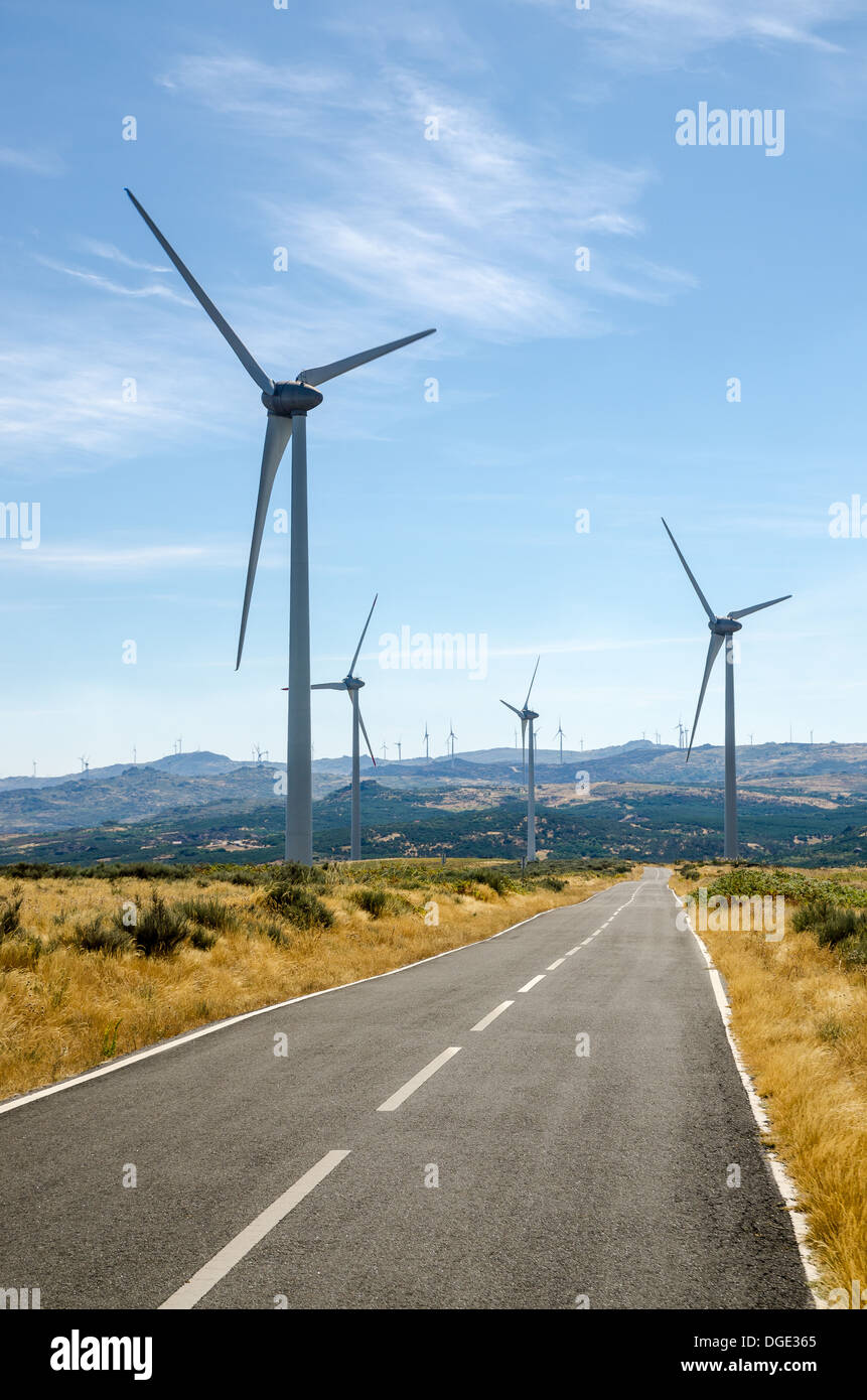 Asphalt road through a wind turbines mountain field Stock Photo - Alamy