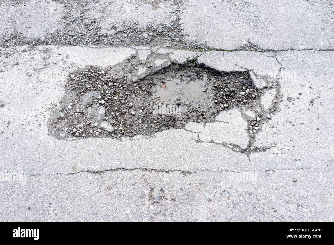 Pothole in UK pavement sidewalk Stock Photo - Alamy