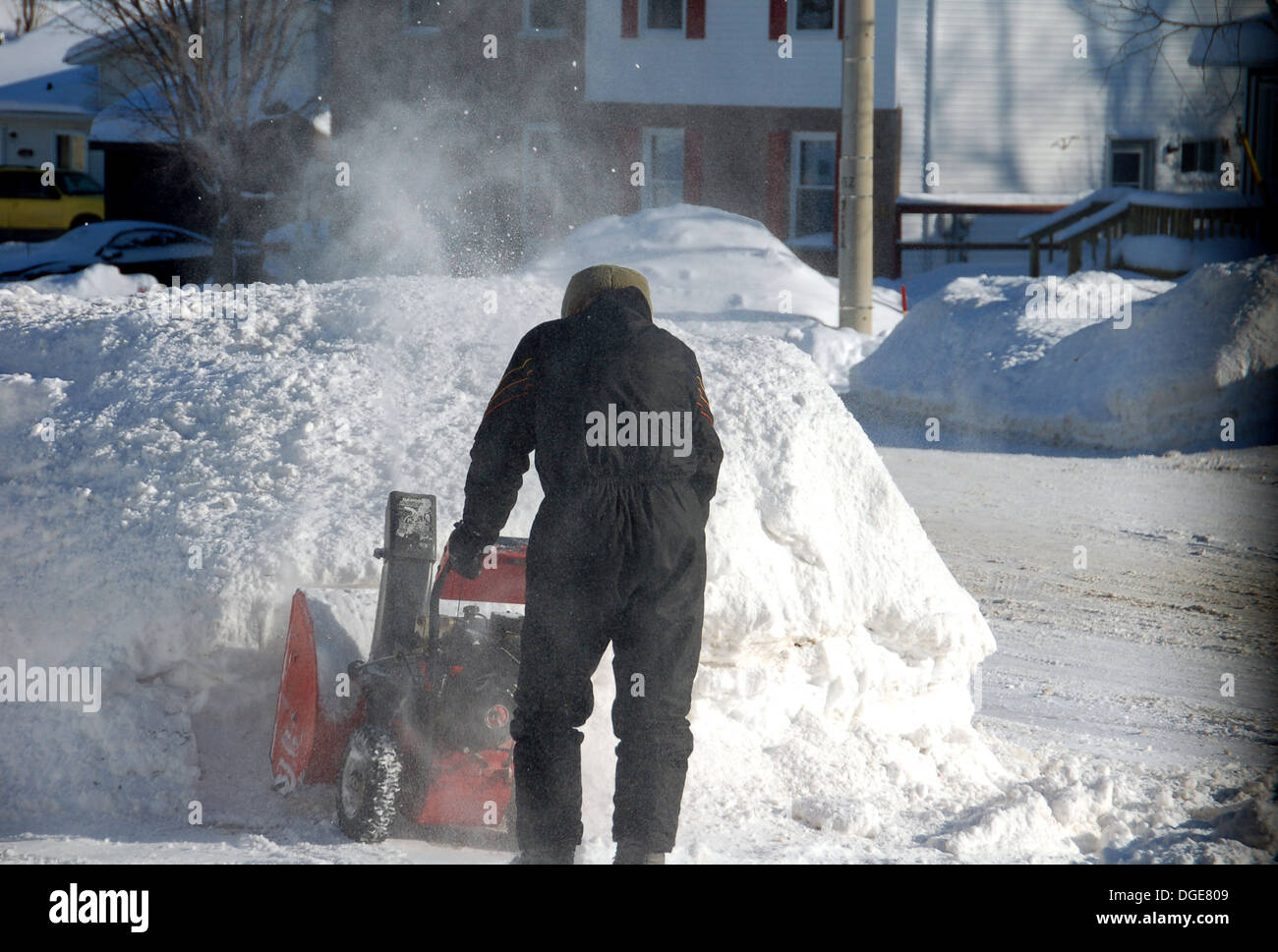 Man clearing snow off his driveway using snow blower Stock Photo - Alamy