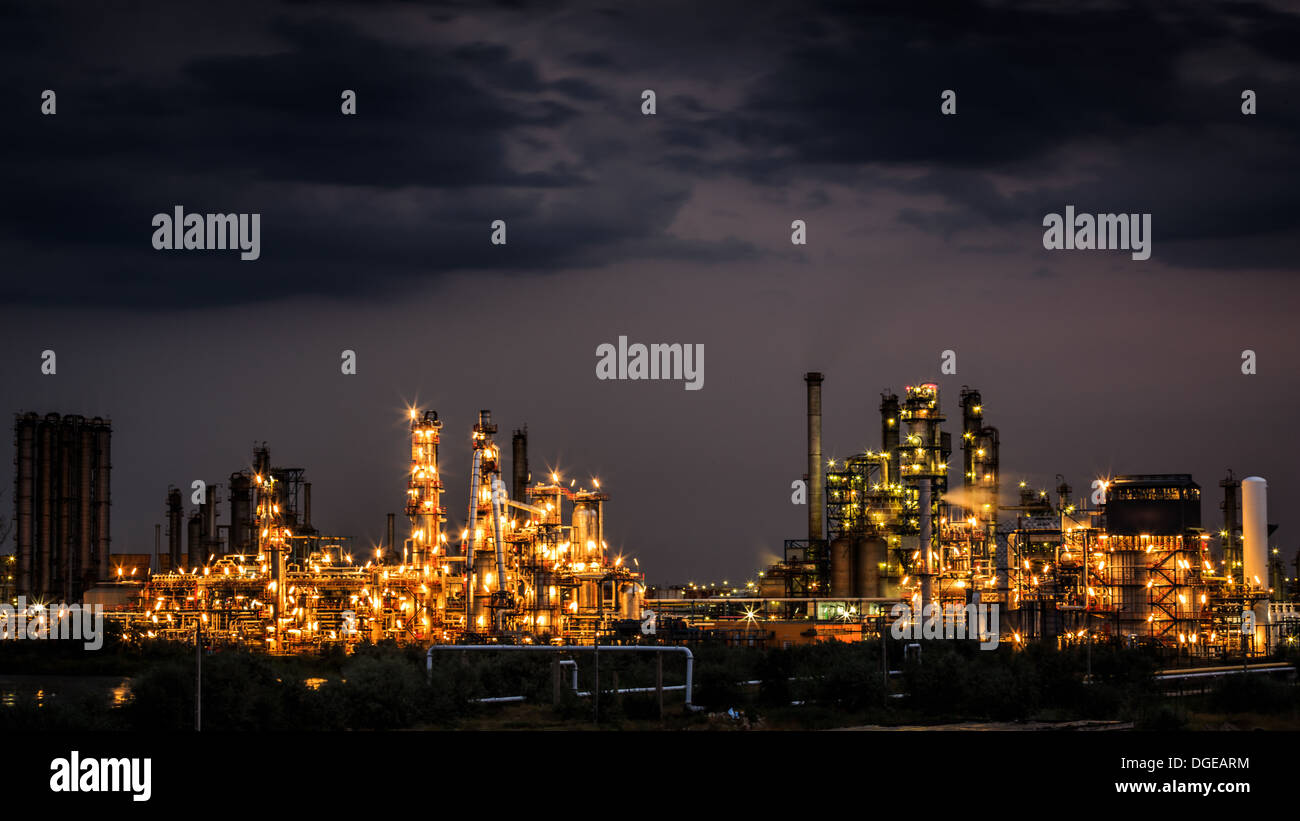 An illuminated oil and gas refinery plant at night in Navodari, Romania ...