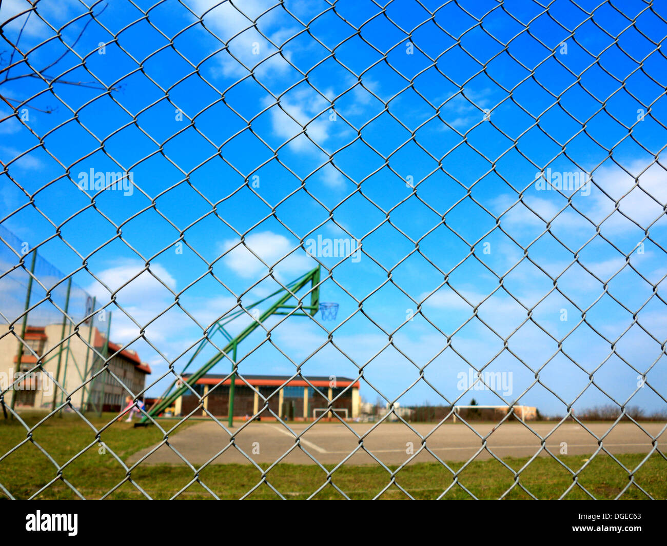 Metal mesh wire fence with blur basketball court background Stock Photo ...