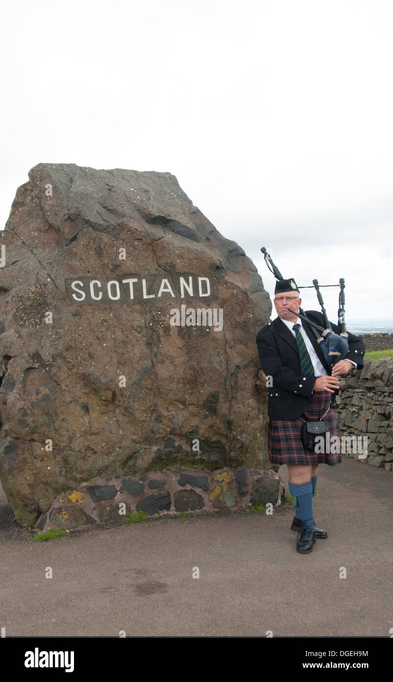 ENGLISH /SCOTTISH BORDER ON A68; PIPER WELCOMING VISITORS TO SCOTLAND ...